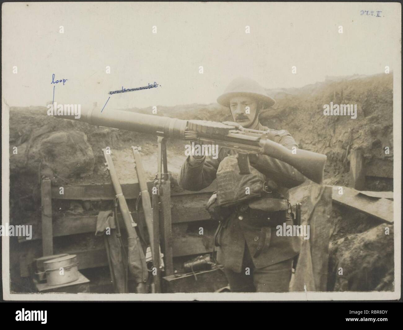 A Lewis Gunner on the La Bassée front in his post, cleaning his gun ...