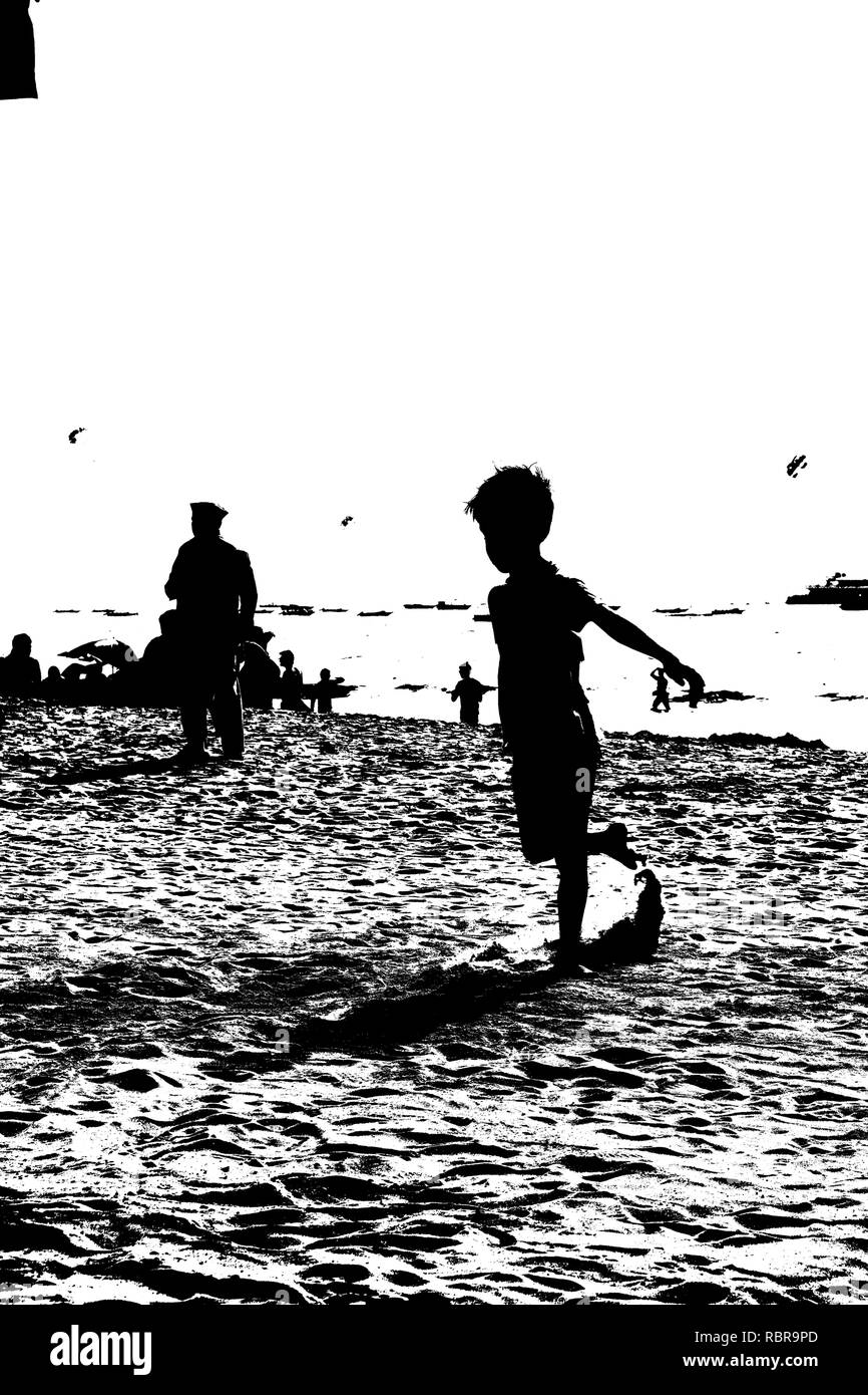 A boy playing on the beach Stock Photo - Alamy