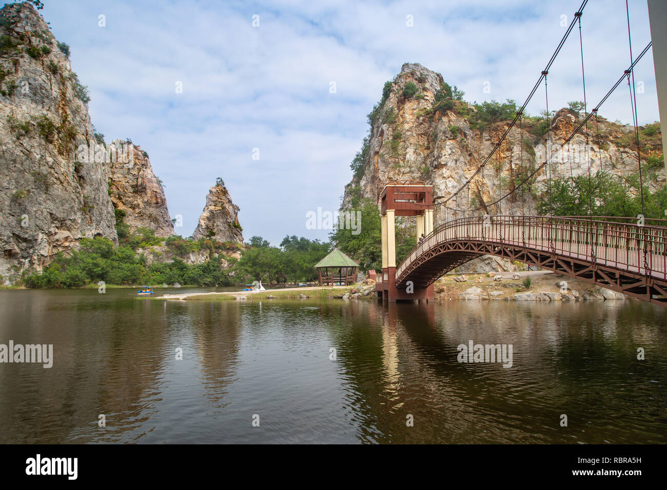 Sling bridge crossing lake in Hin Khao Ngu stone park, Thailand Stock ...