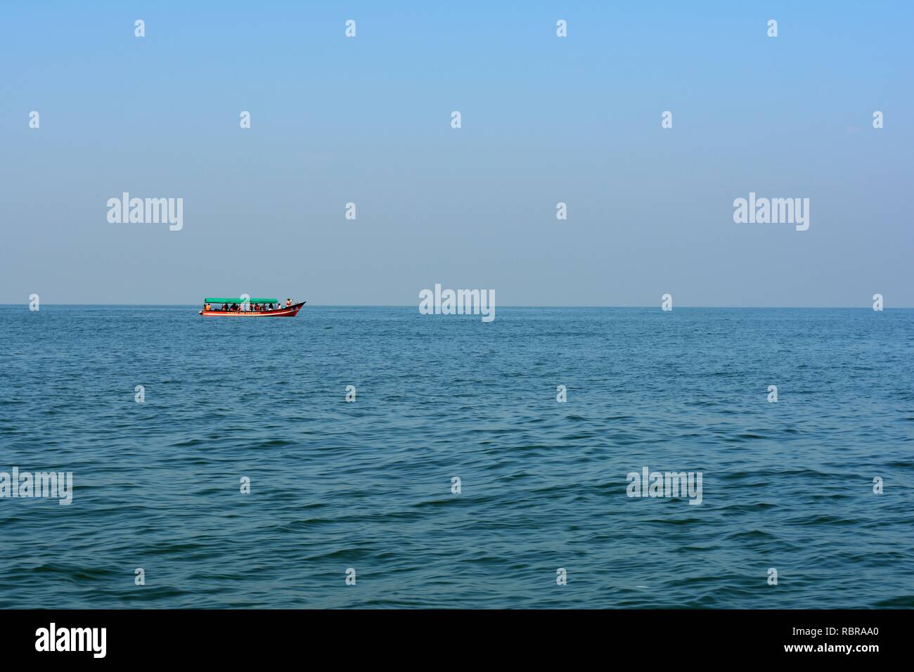 Small isolated boat in the middle of ocean Stock Photo - Alamy