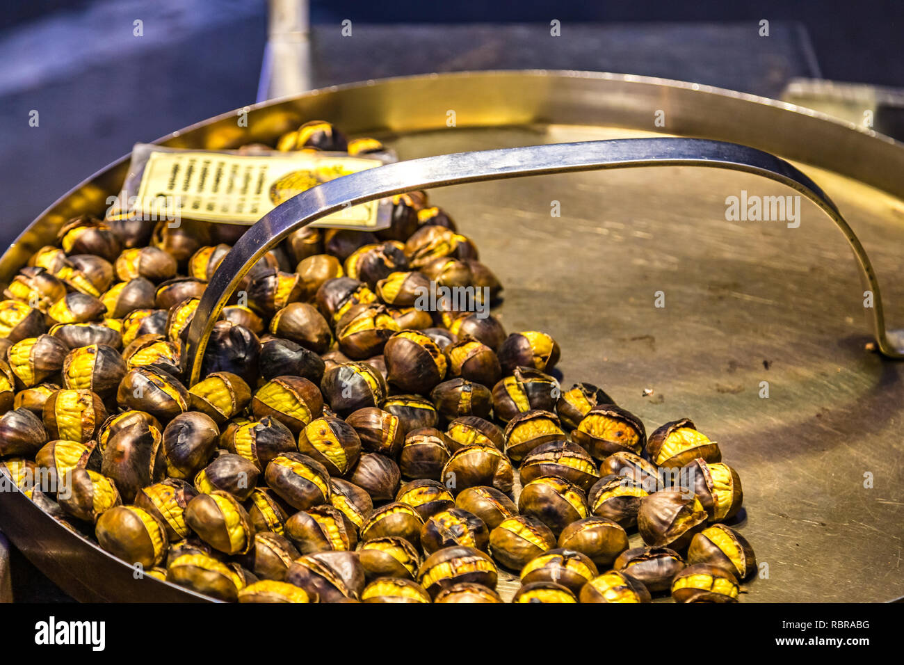 roasted chestnuts in pan of street stall Stock Photo - Alamy