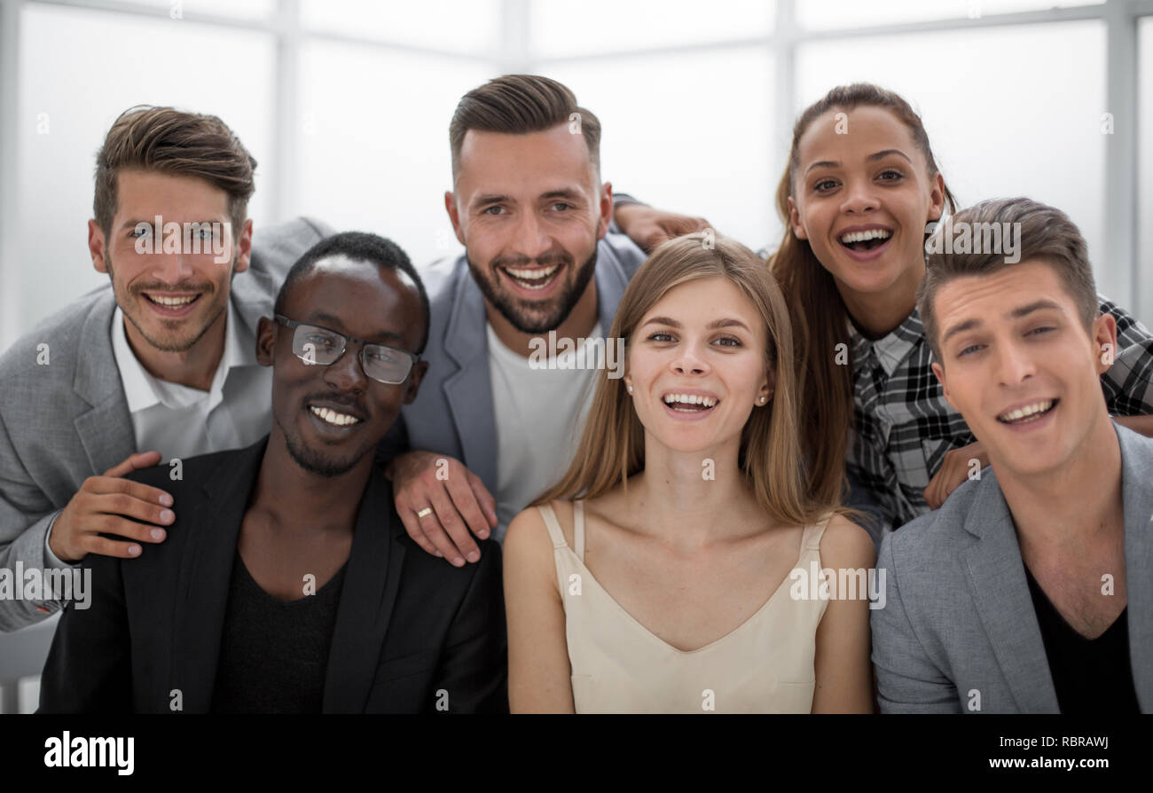 Group of young executives smiling at camera during a work meetin Stock ...
