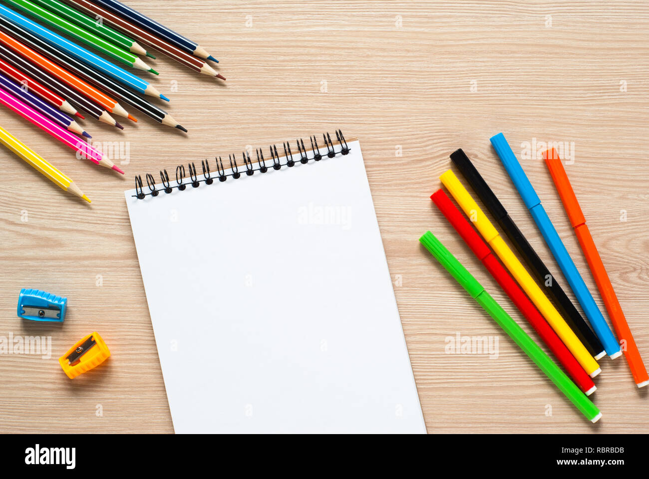 Pencils, crayons and notebook on a desk. Top view with copy space Stock ...