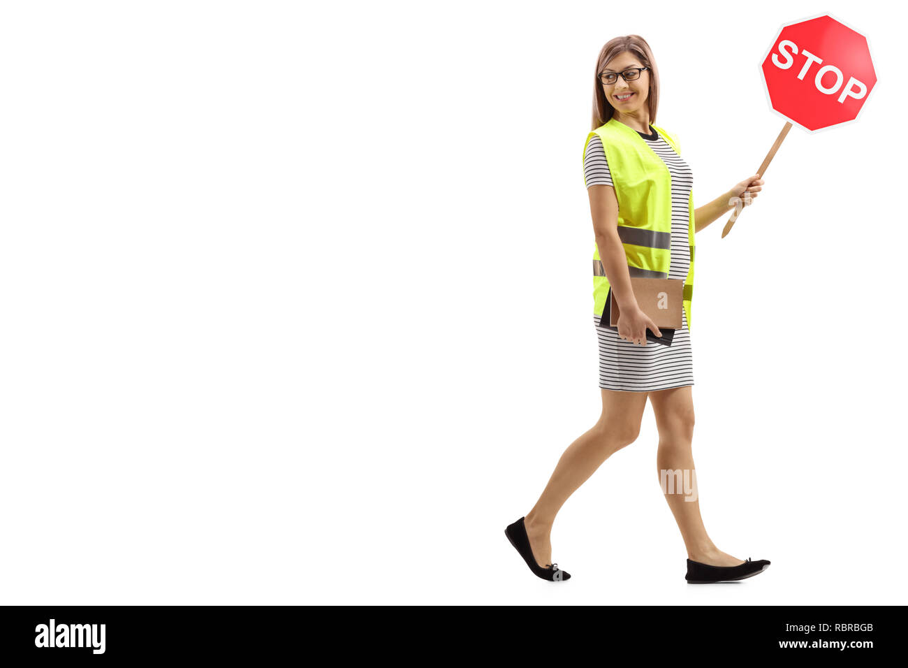 Full length shot of a young woman with safety vest and stop sign ...