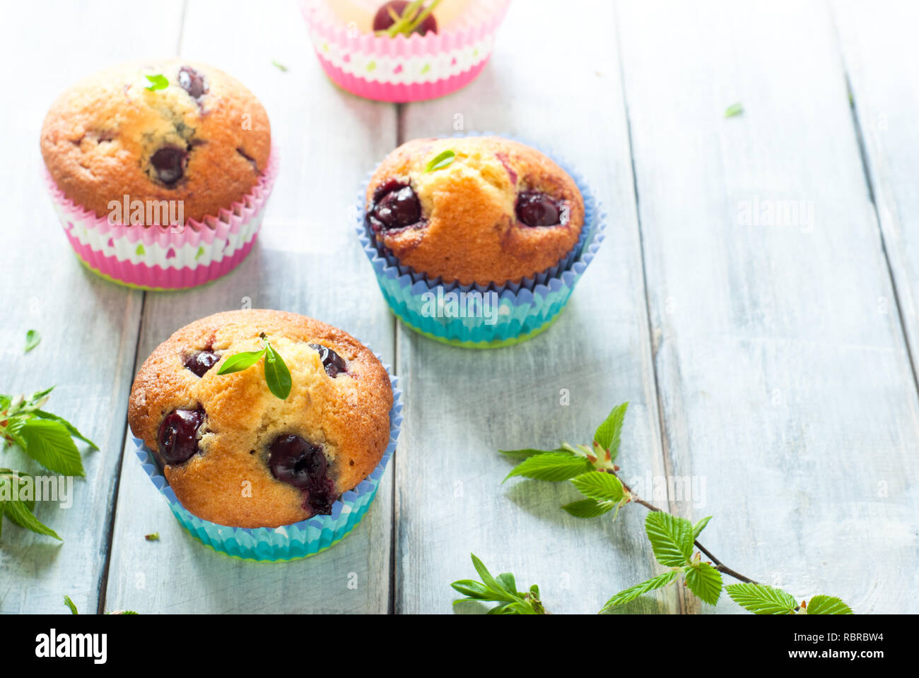 Summer muffins with cherry at wooden table Stock Photo - Alamy
