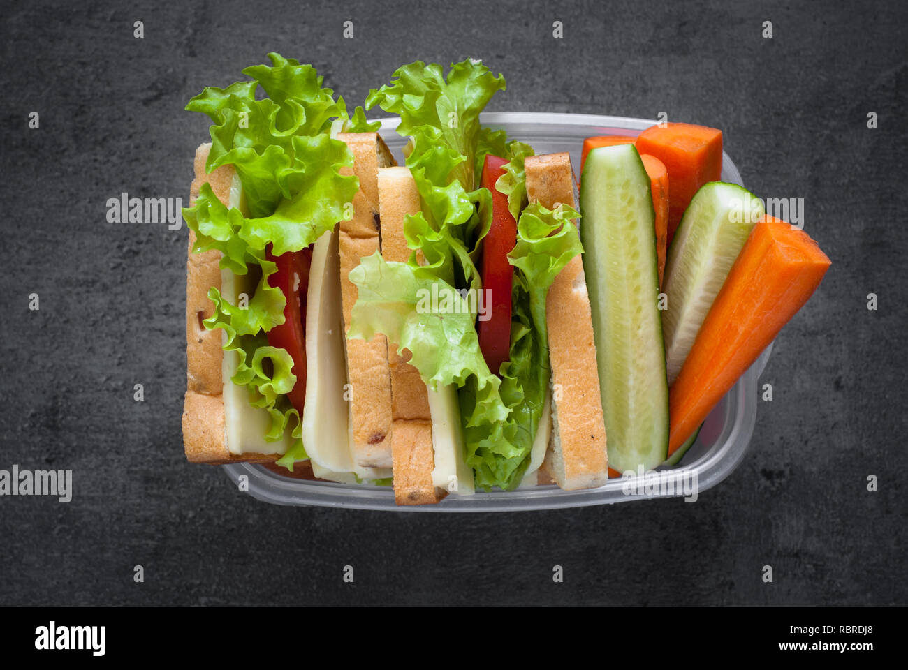 Lunch box with sandwich on black background. Healthy eating. Flat lay ...