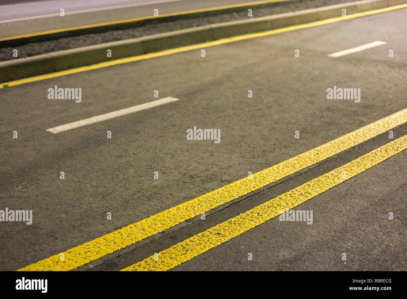 Wide bright yellow street marking sign line along modern wide smooth ...