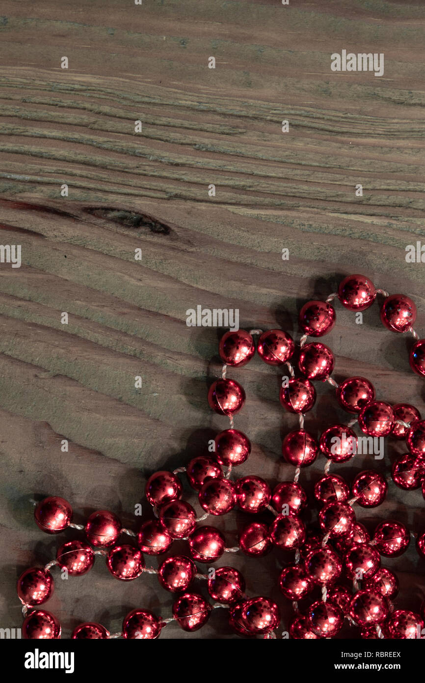 Bright red metallic beads on rustic wood surface Stock Photo - Alamy