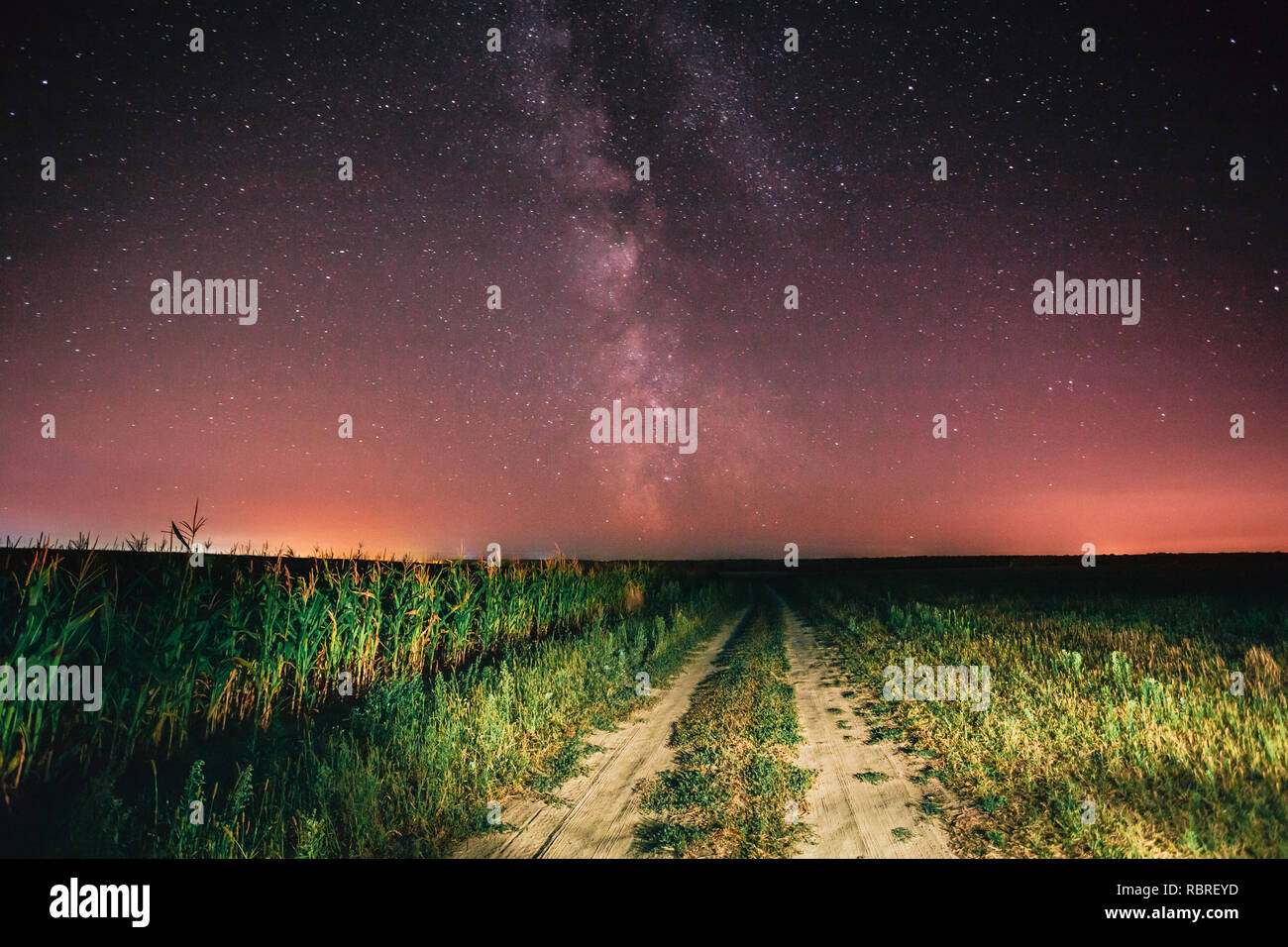 Night Starry Sky With Milky Way Glowing Stars And Country Road In ...