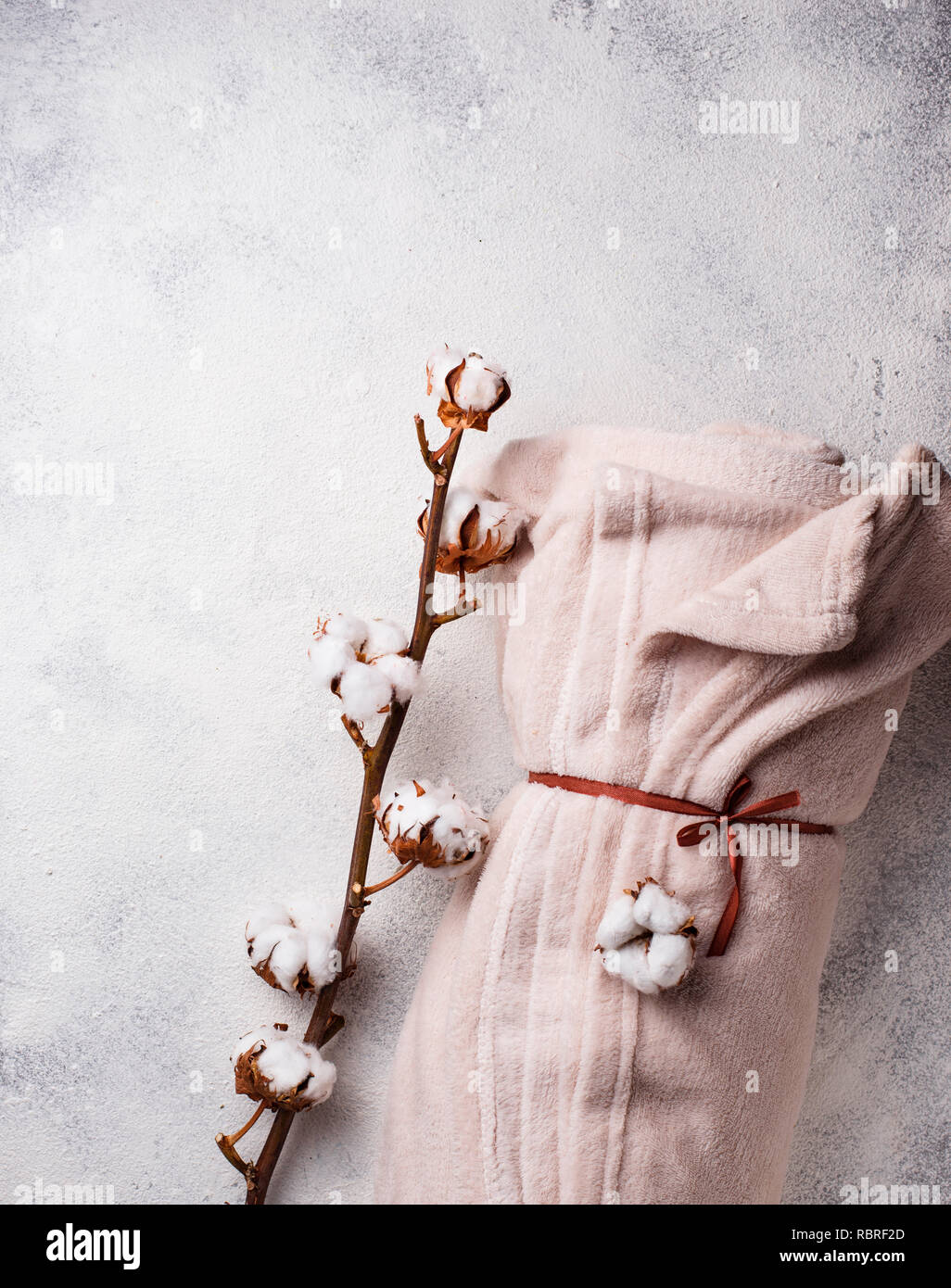 Cotton branch and blanket on light background Stock Photo - Alamy