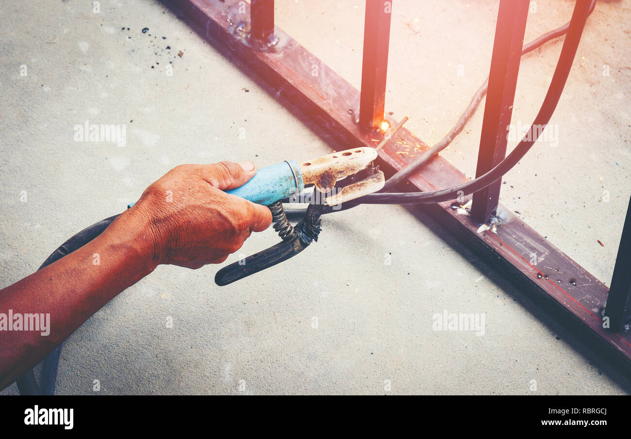Welding Steel / Hand man worker Welder in factory Stock Photo - Alamy