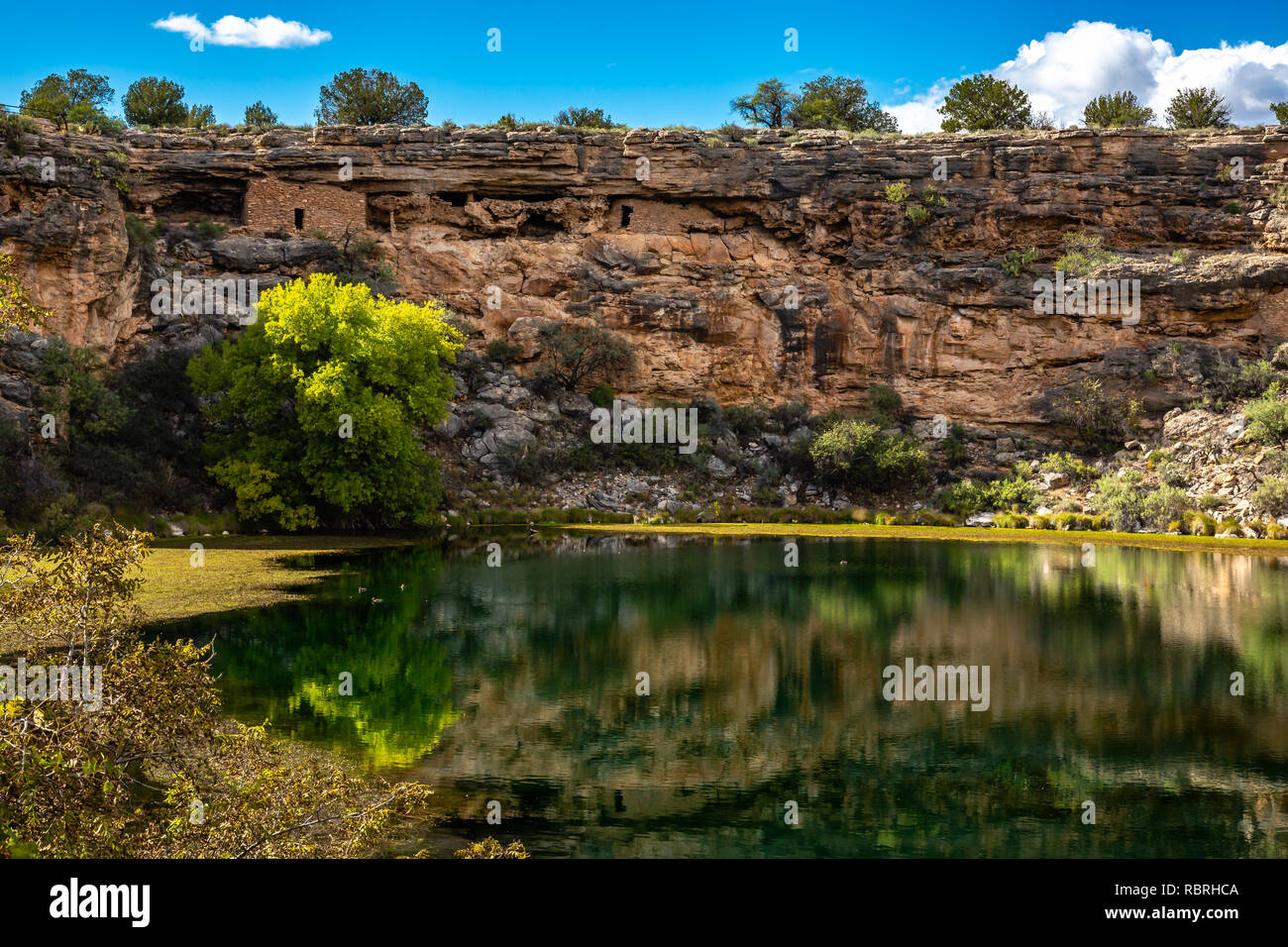 Ancient ruins and surroundings reflect on the quiet water of Montezuma ...