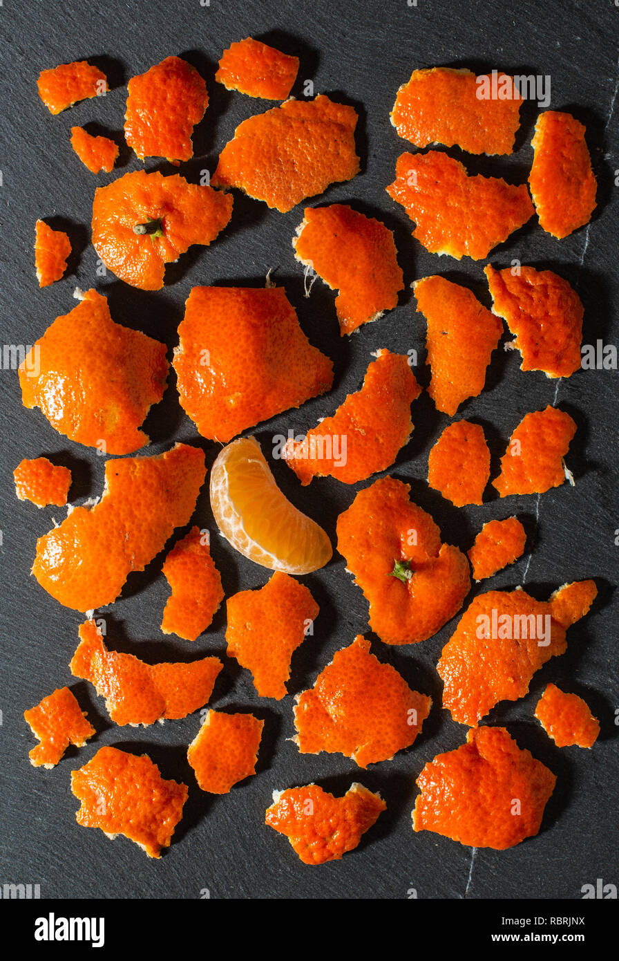 Mandarin and orange peels on a dark background. Backdrop of citrus ...