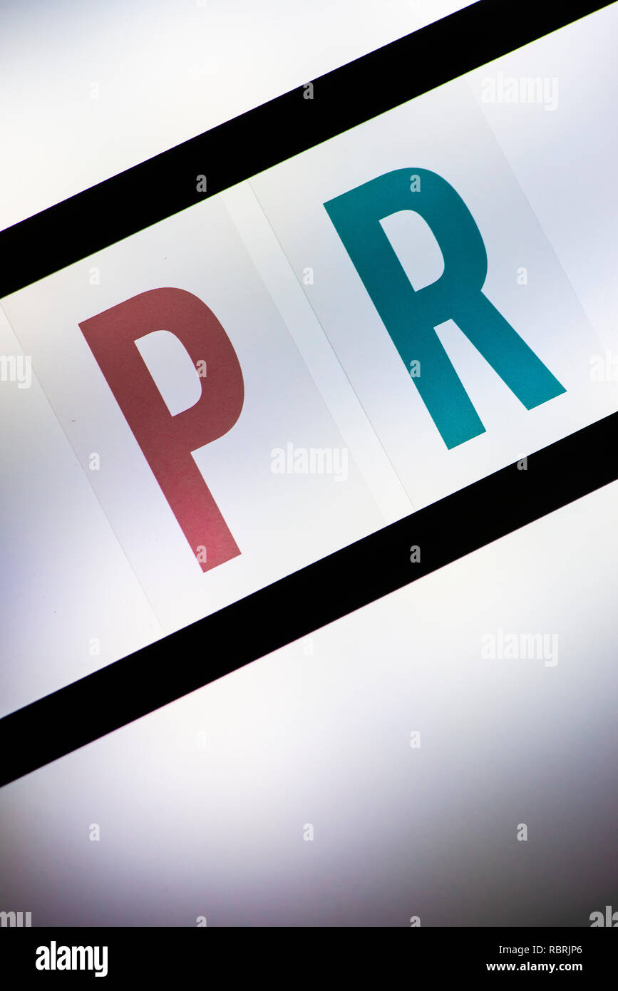 PR letters on backlight board. Colored Characters P and R on white ...