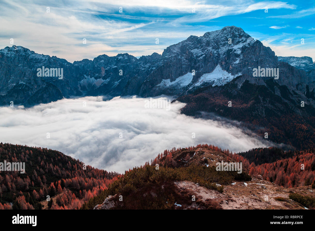 Clouds in the valley under the peak of Julian Alps Stock Photo - Alamy