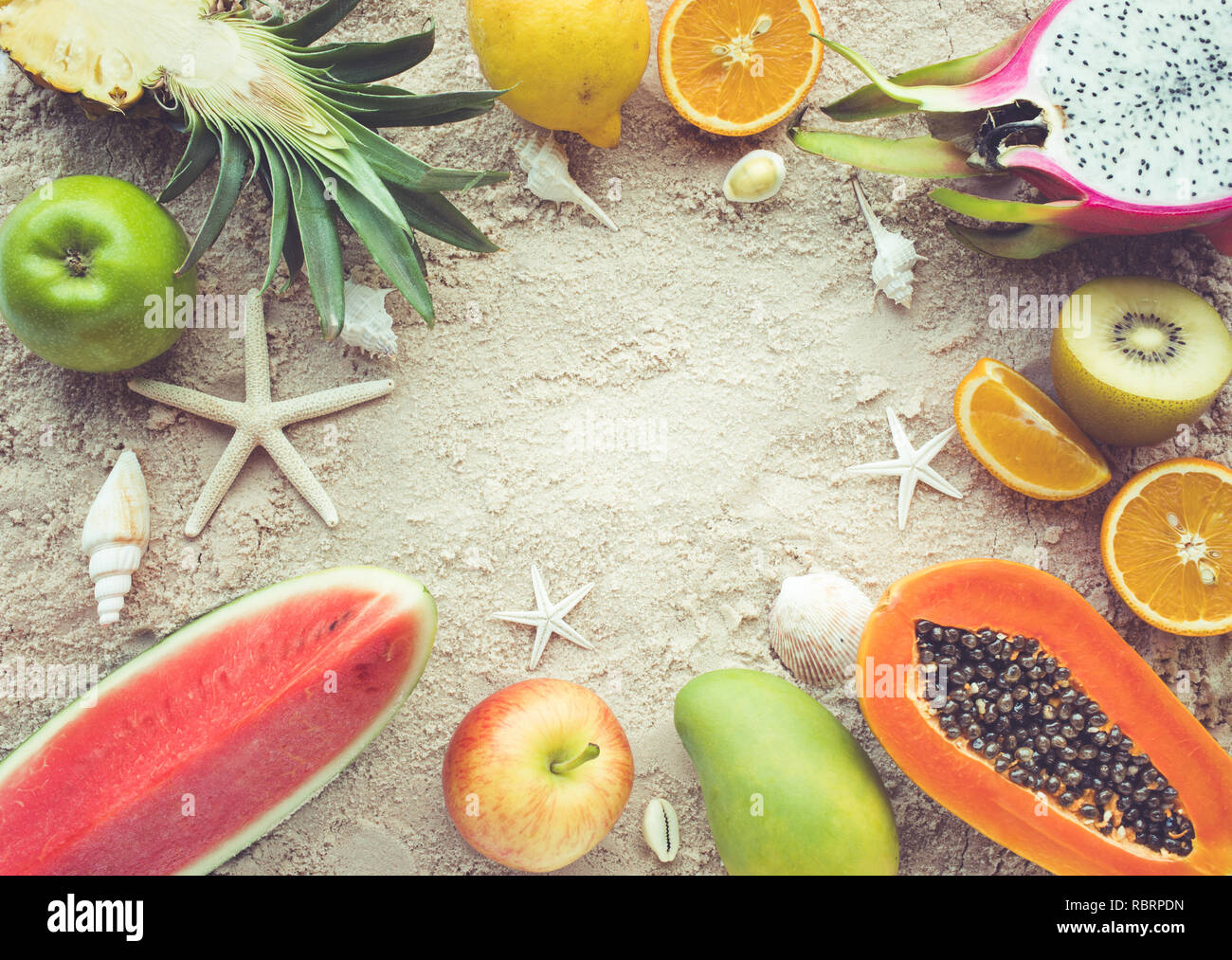 Group of fruits on sand background with shells.Top view Stock Photo - Alamy