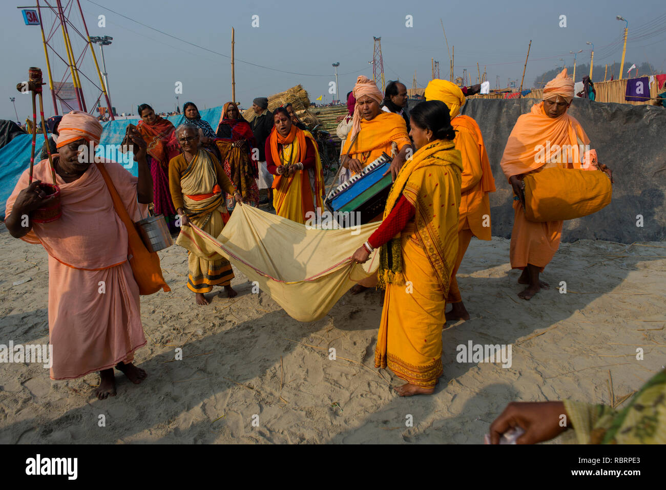Pilgrims sing and dance asking for alms at Gangasagar fair Stock Photo ...