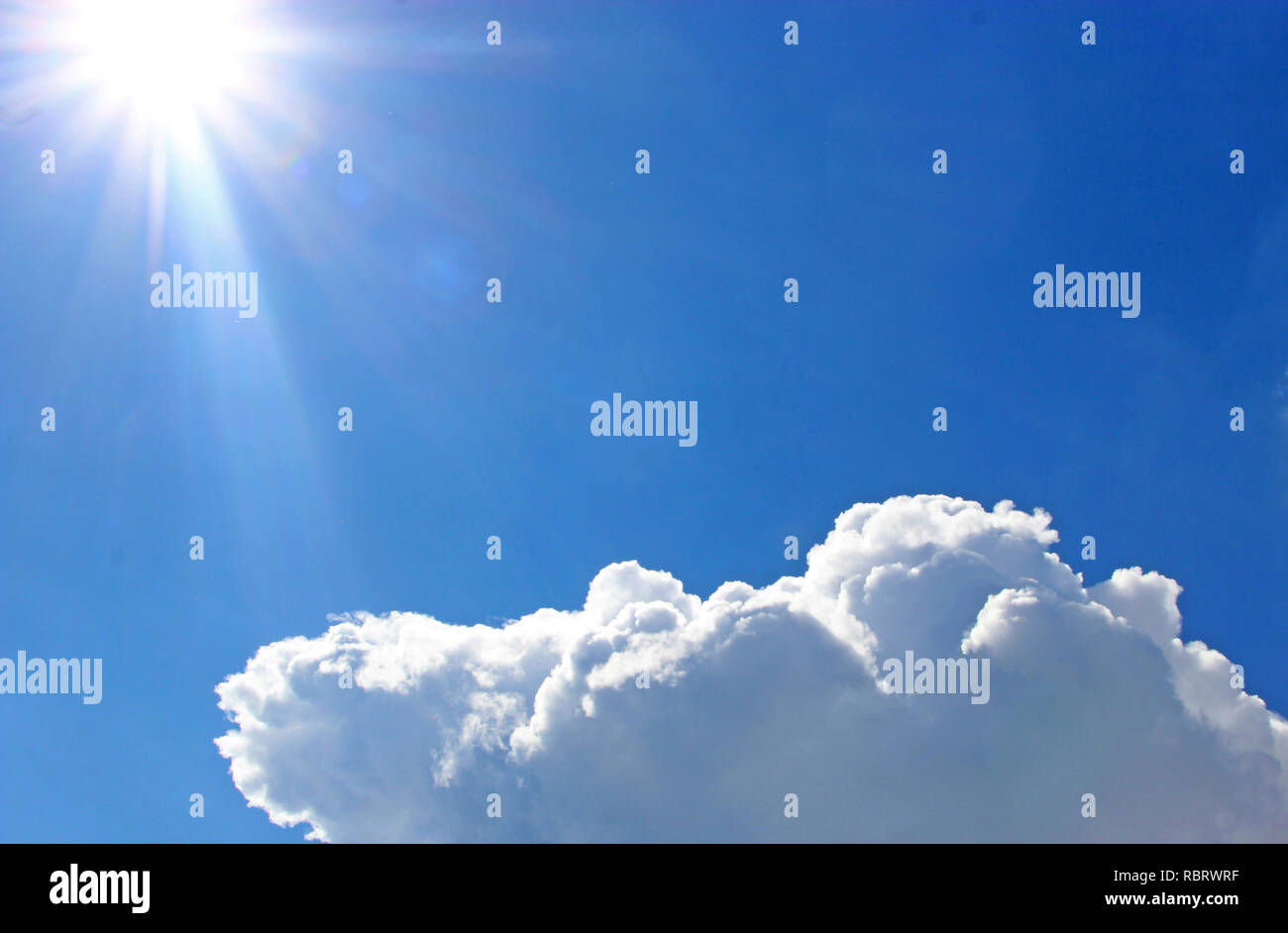 summer, blue sky, sunrays and a white cloud Stock Photo - Alamy