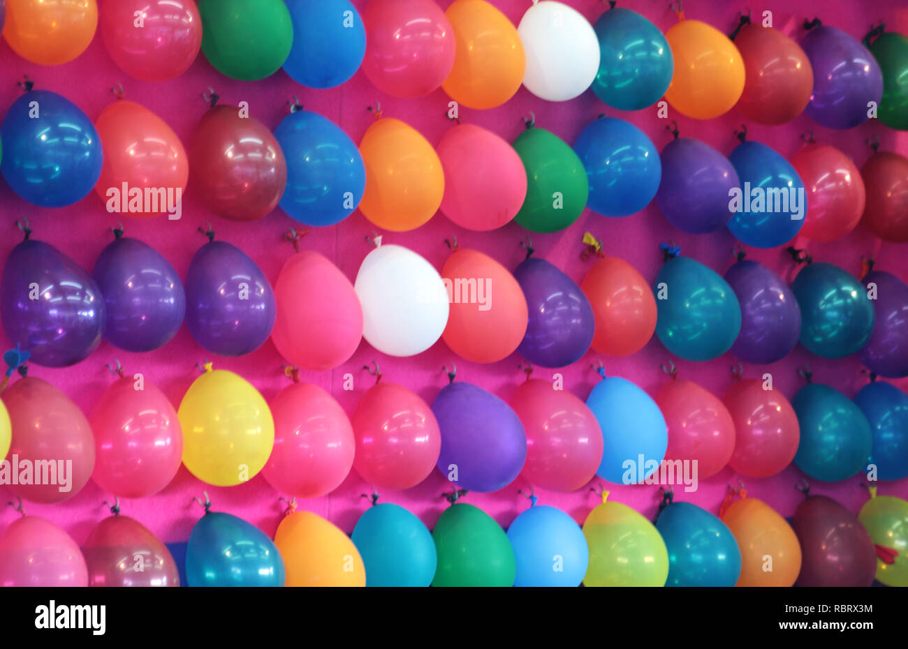 multi colored ballons for a dart game on a fair Stock Photo - Alamy