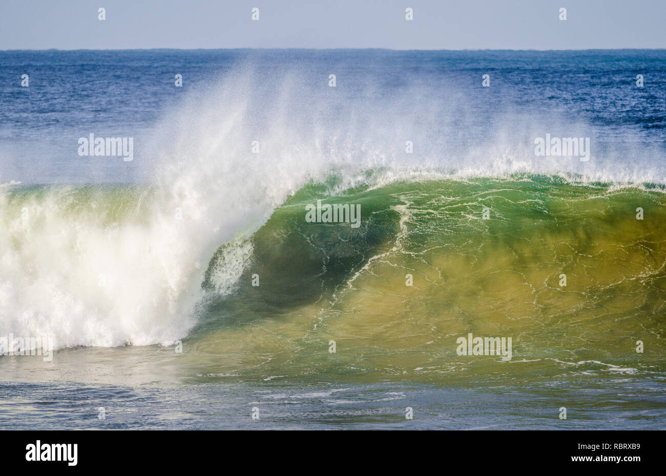 Large breaking wave exploding on the shore Stock Photo - Alamy