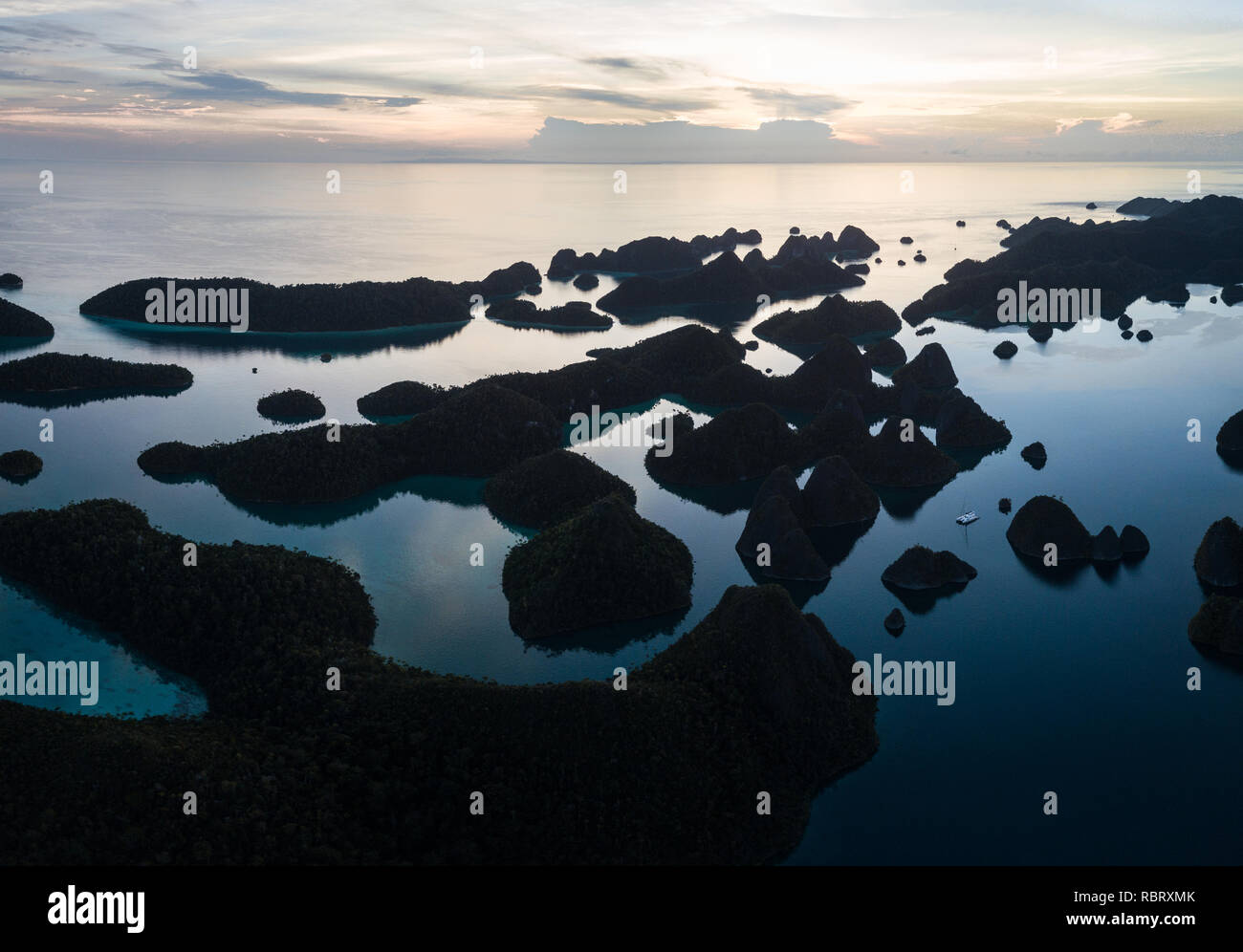 Remote limestone islands form a maze in a tropical lagoon in Raja Ampat ...