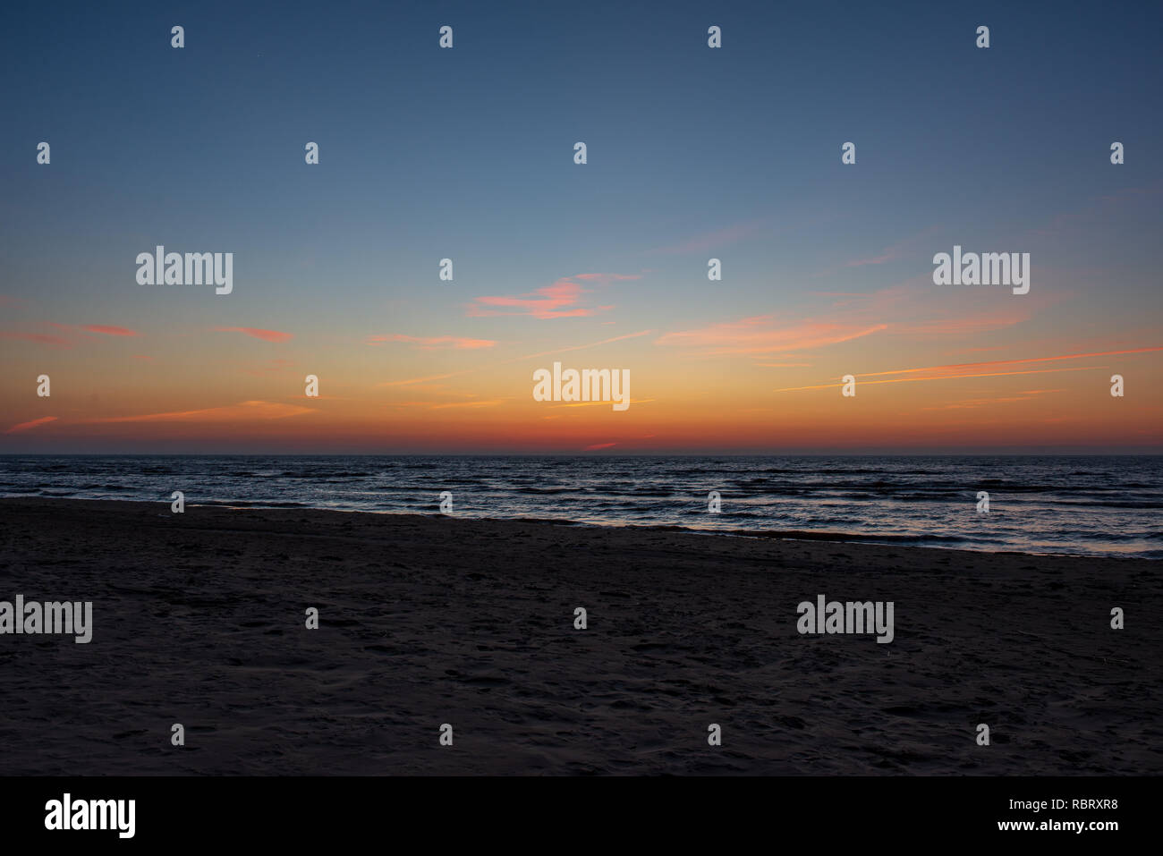 beautiful. red sunset over the sea, lake with clear sky and reflections ...