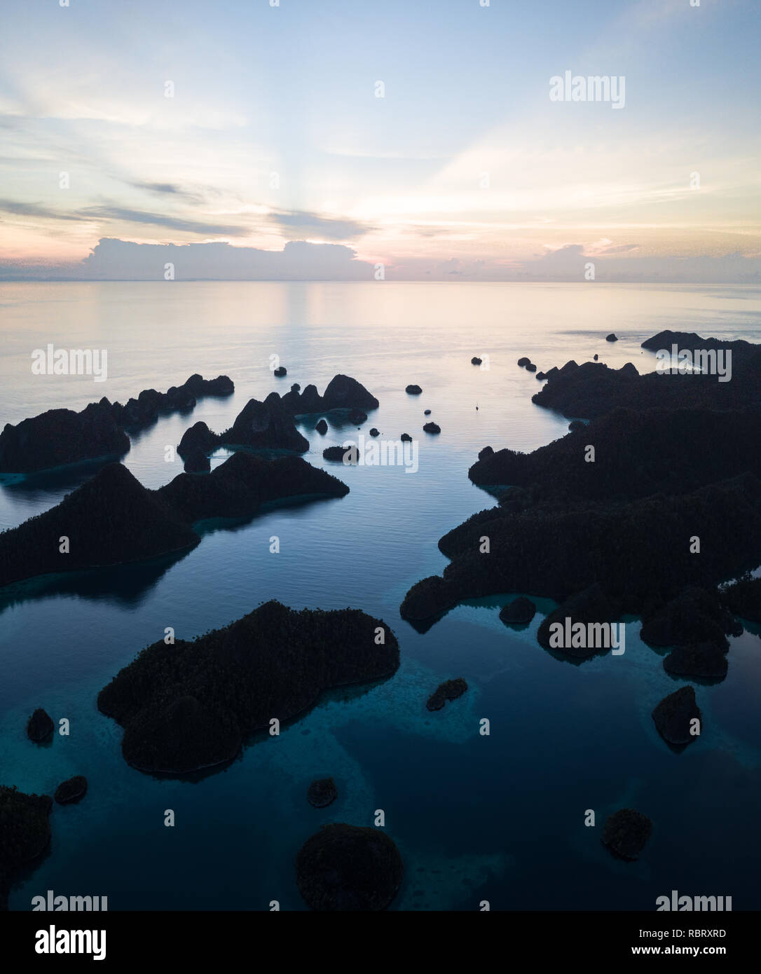 Remote limestone islands form a maze in a tropical lagoon in Raja Ampat ...