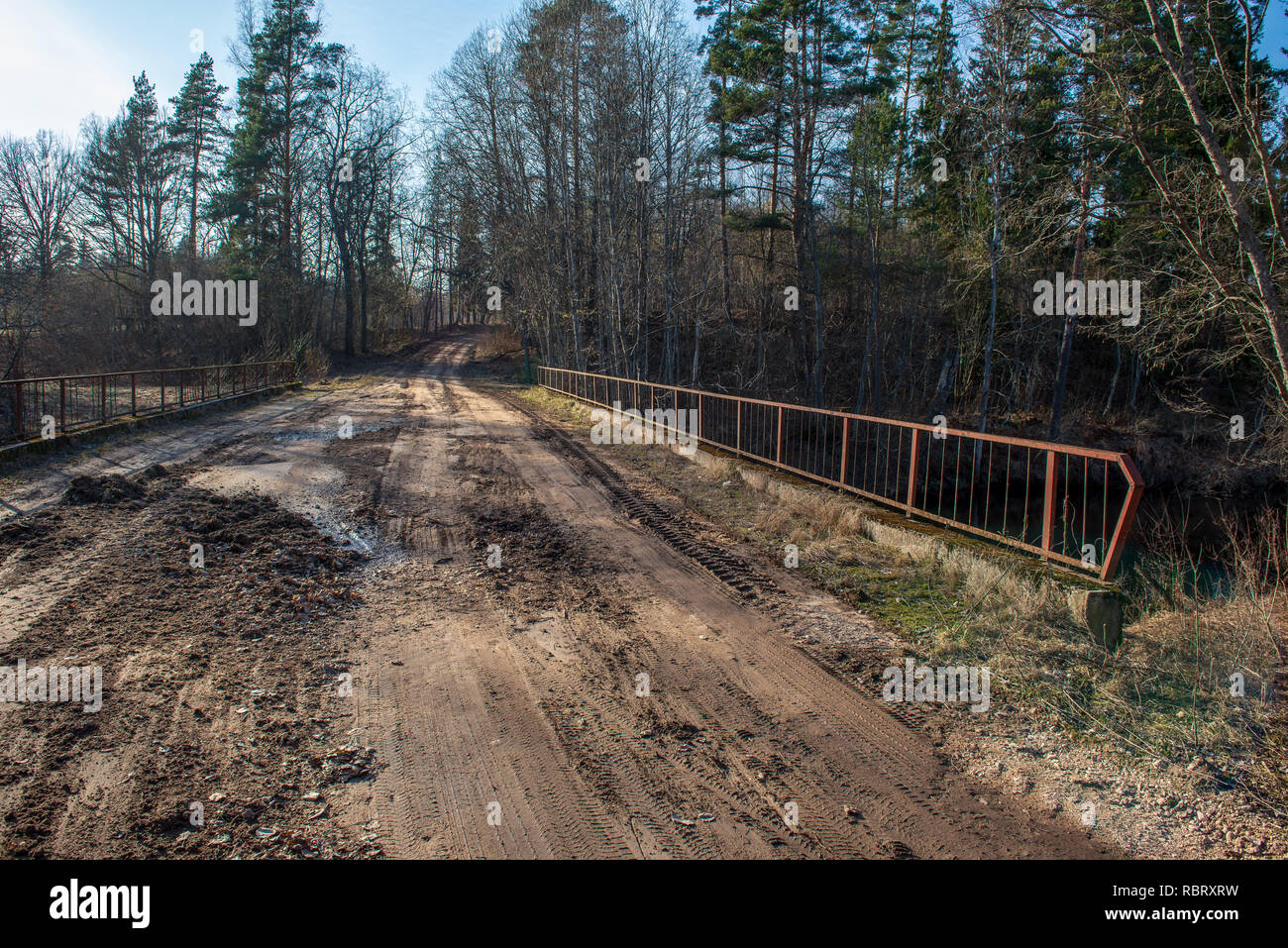 country gravel road in perspective with old and broken asphalt in ...