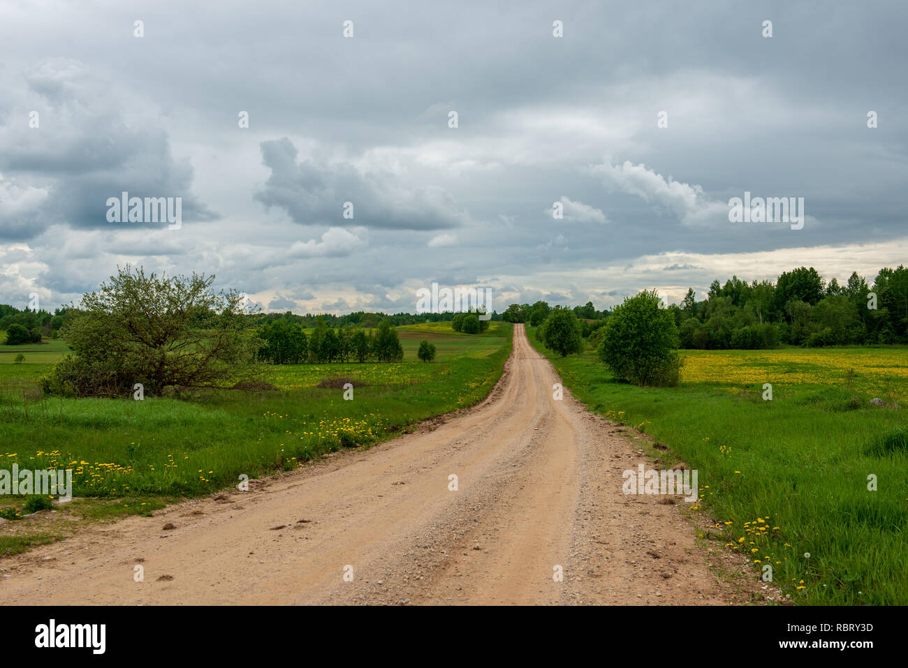 country gravel road in perspective with old and broken asphalt in ...