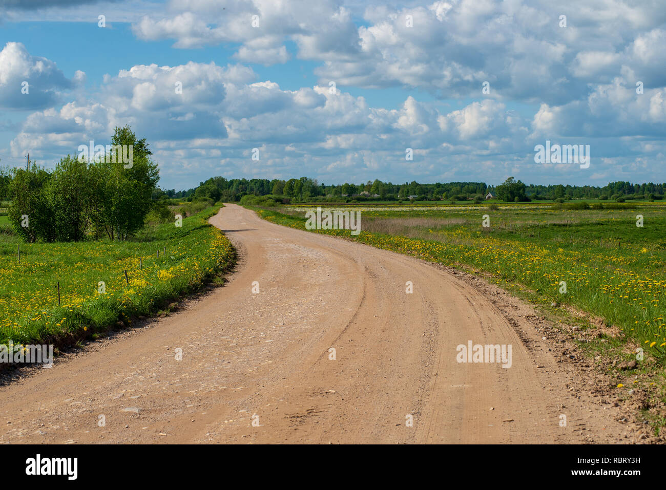 country gravel road in perspective with old and broken asphalt in ...