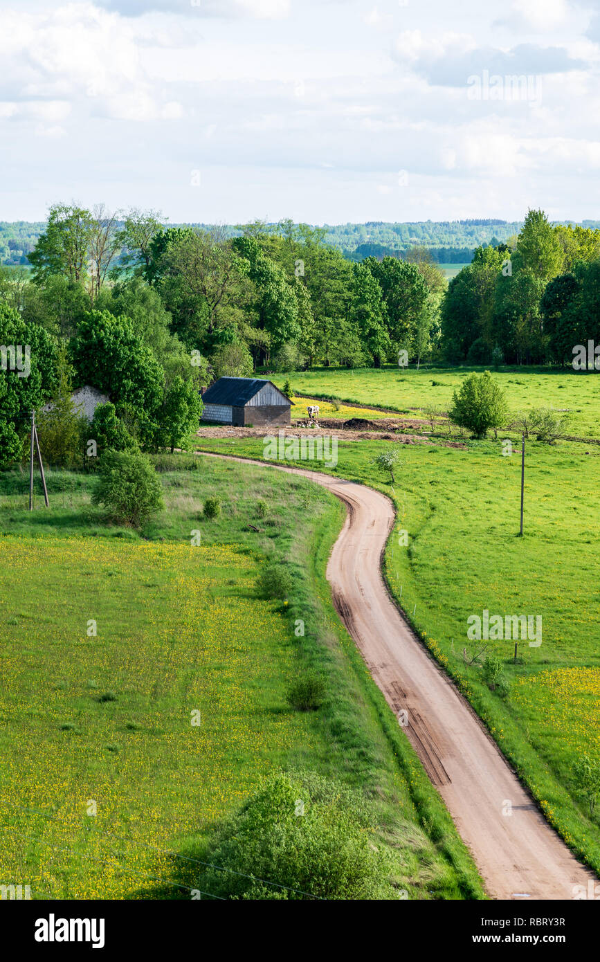 country gravel road in perspective with old and broken asphalt in ...