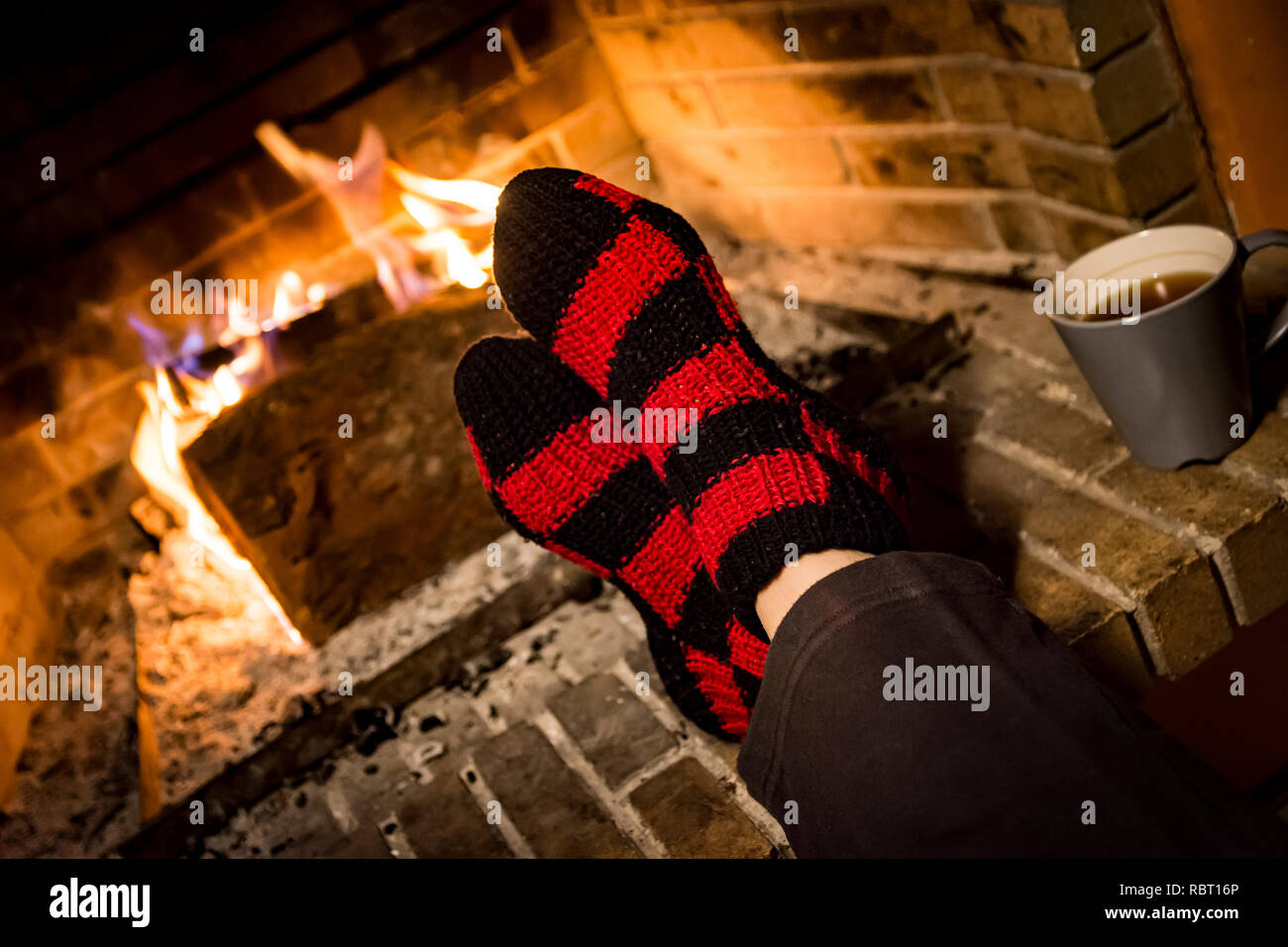 womans feet while she is warming in a fireplace Stock Photo - Alamy