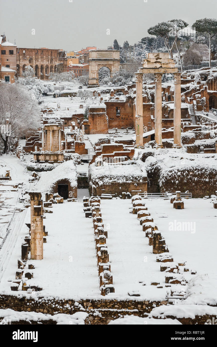 Winter in Rome. View of Roman Forum ancient ruins and Coliseum covered ...