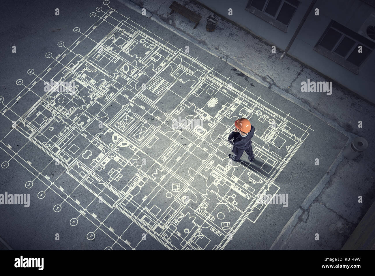 Man engineer thinking over his plan. Mixed media Stock Photo - Alamy