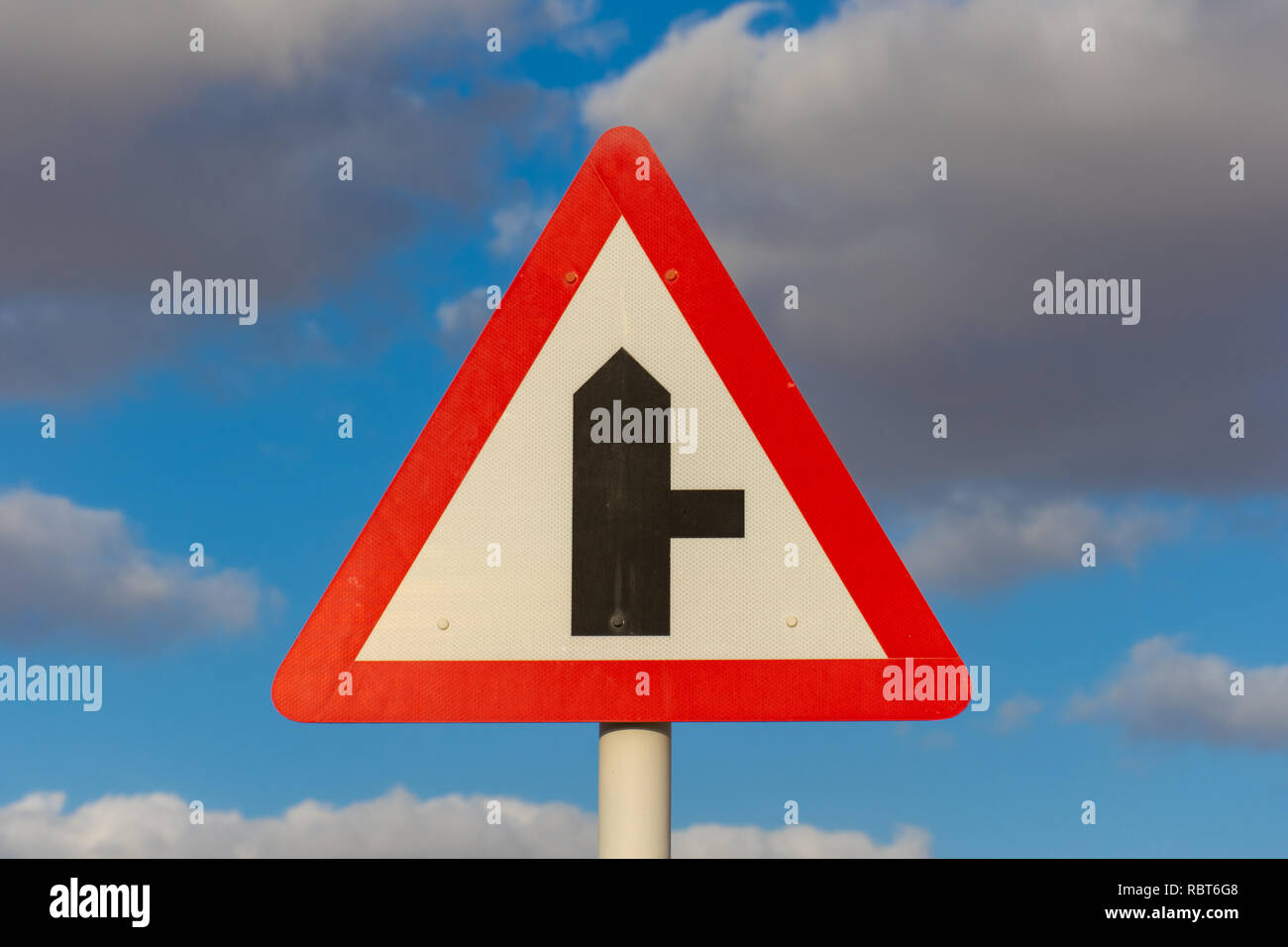 Fork in the road on right sign with blue sky and clouds in background ...