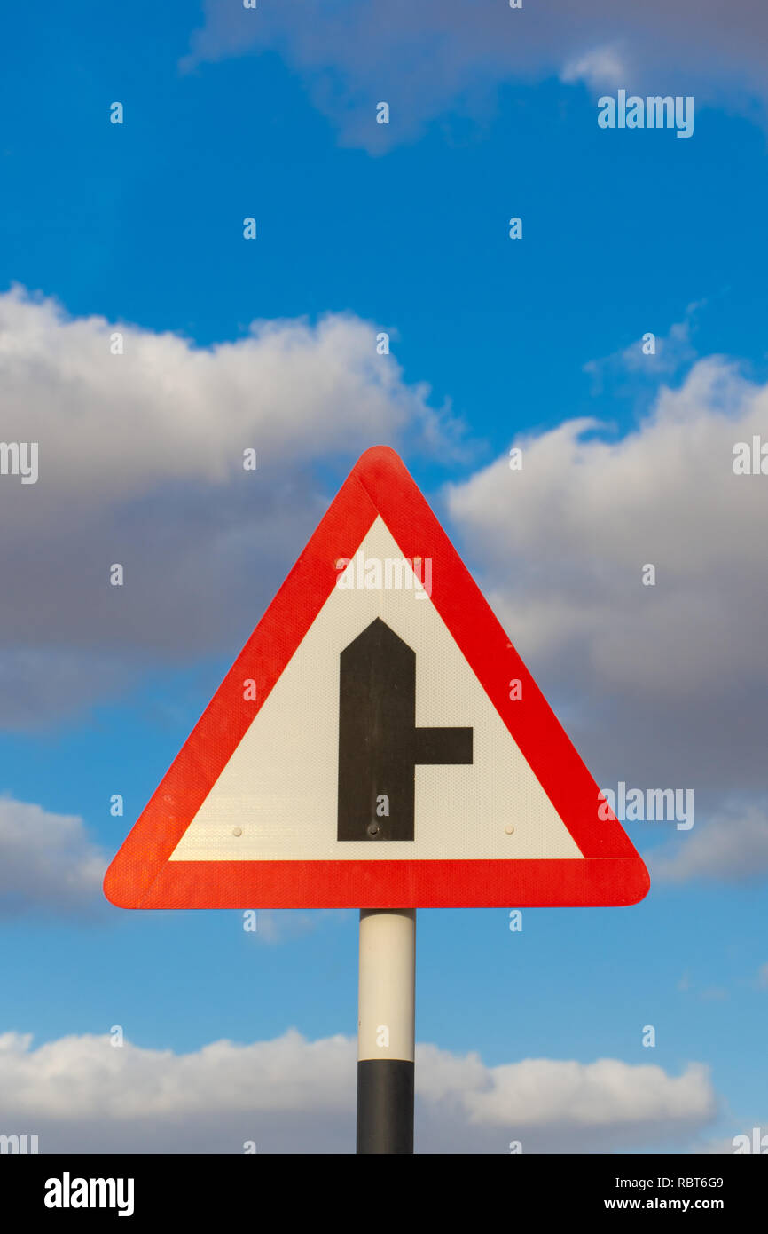 Fork in the road on right sign with blue sky and clouds in background ...