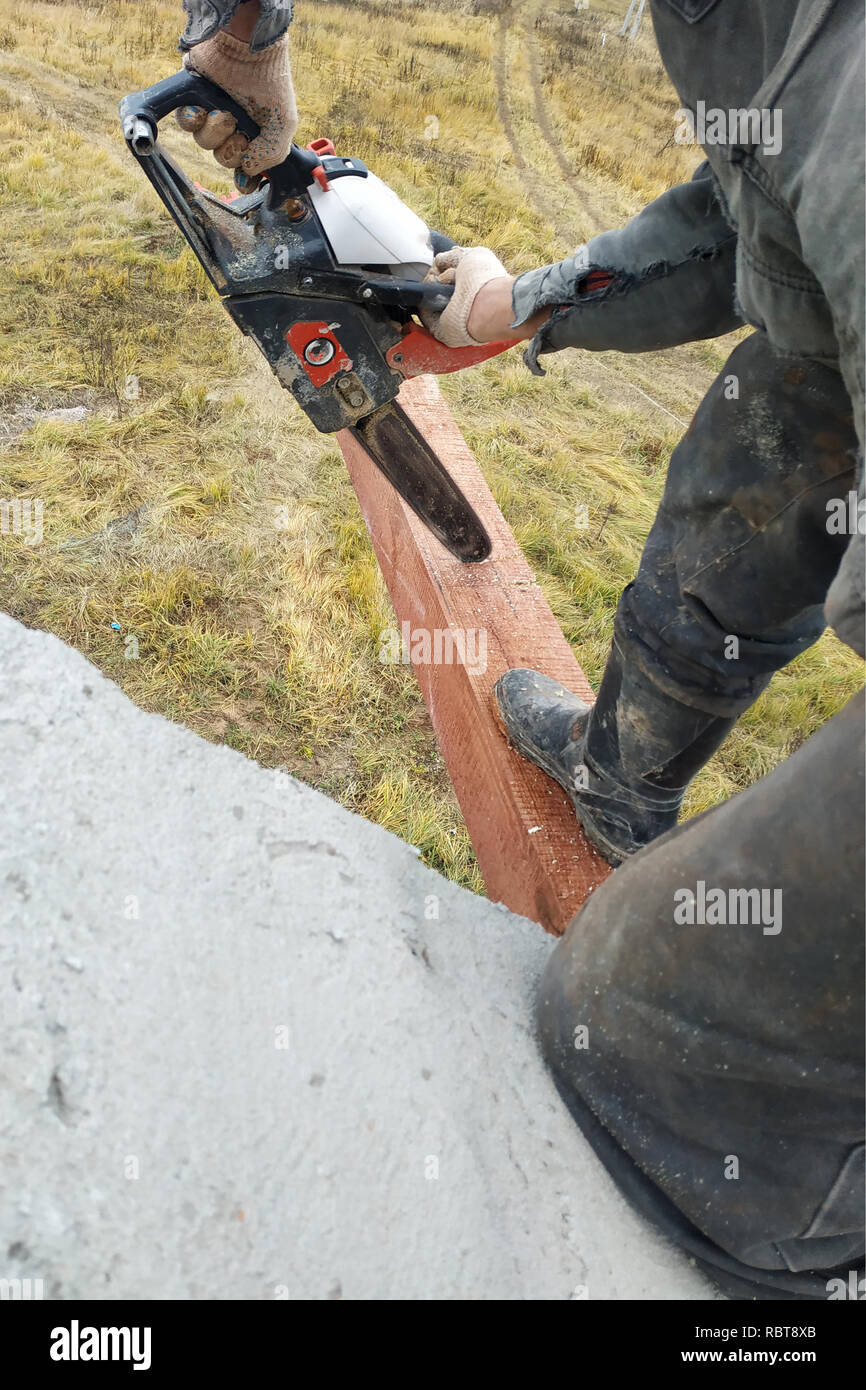 The master uses a saw to handle and cut timber beam 2018 Stock Photo ...