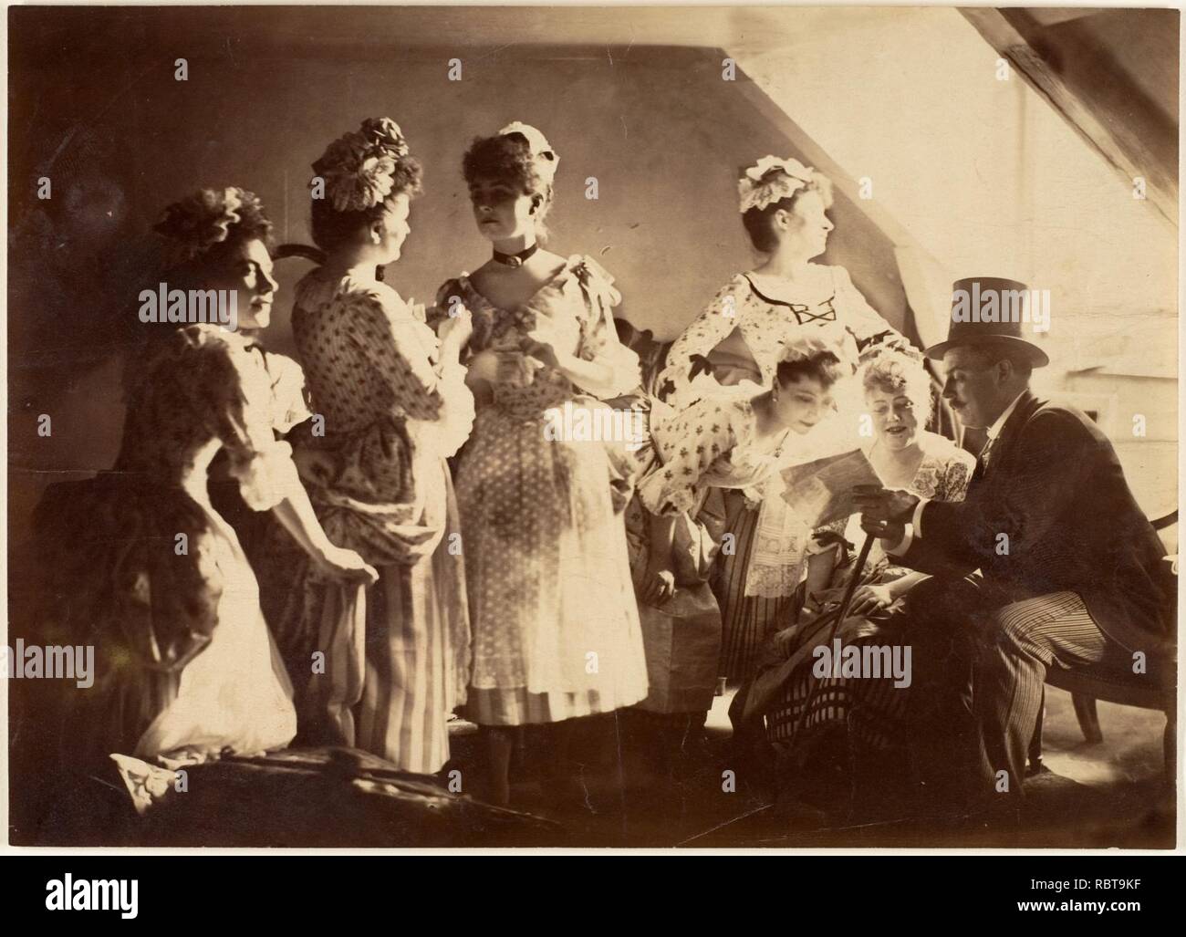 -A Group of Six Costumed Women Posed in Interior with Top Hatted ...
