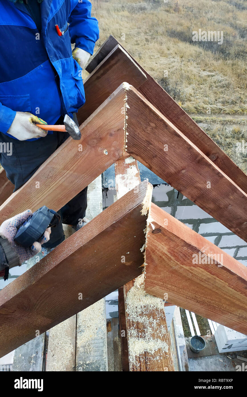 the worker shoots the rafters on the roof frame Stock Photo - Alamy