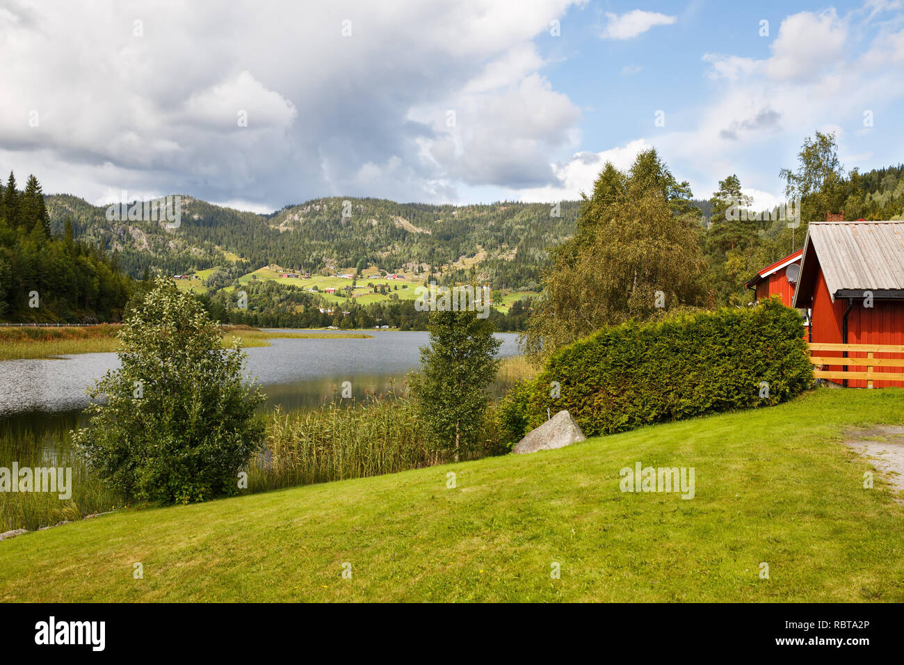 Beautiful rural scene with village, lake amd mountains in Norway Stock ...