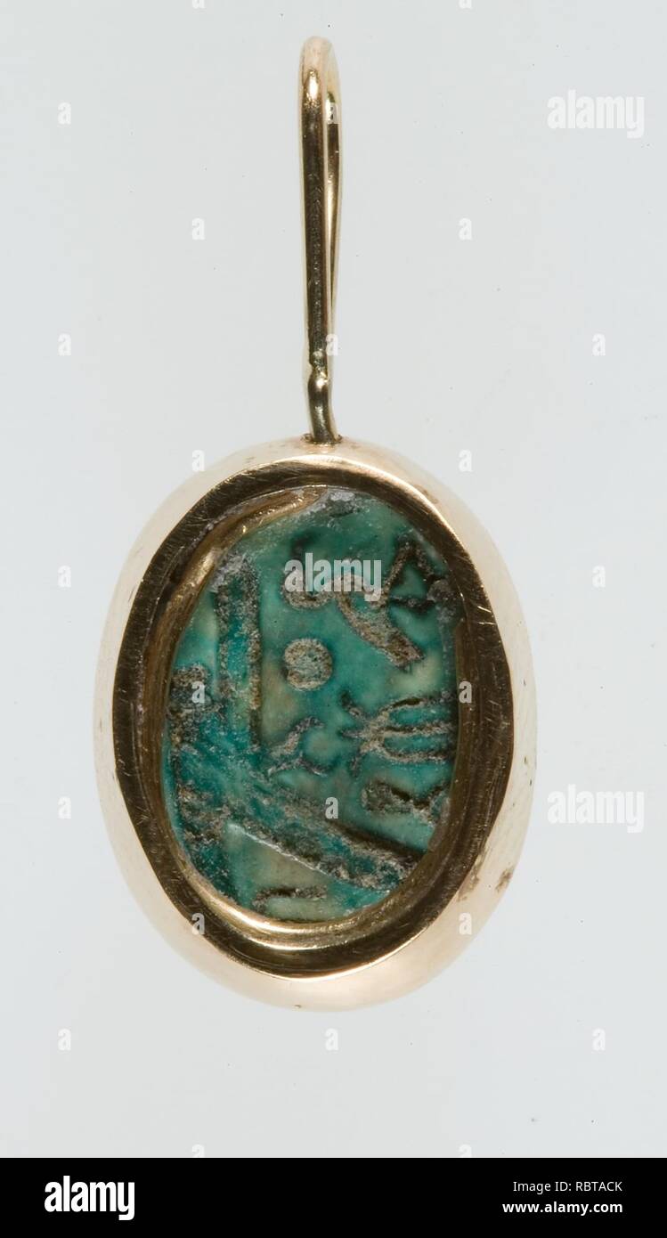 A modern pendant setting holding an inscribed scarab Stock Photo - Alamy