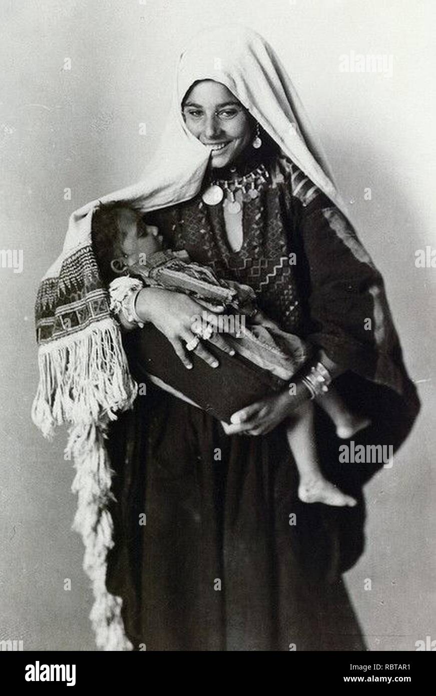 A Palestinian Mother Smiling with her child in her arms Stock Photo - Alamy