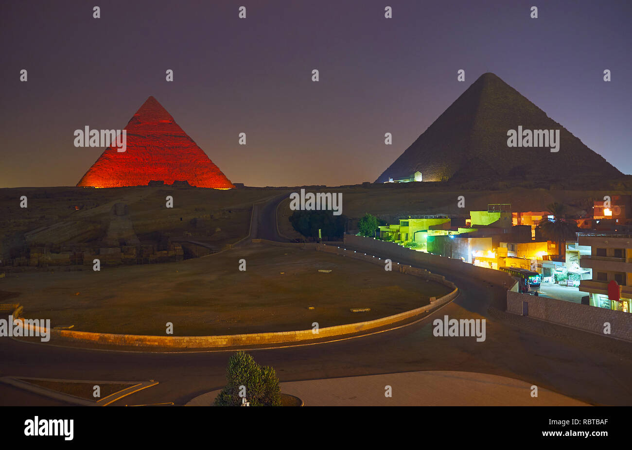 The brightly illuminated Great Pyramids in Necropolis of Giza on dark ...