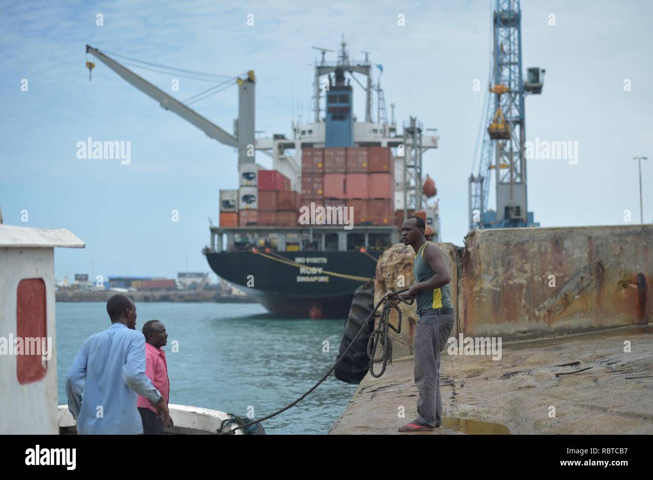 A Somali man helps dock a smaller boat in Mogadishu's port on September ...