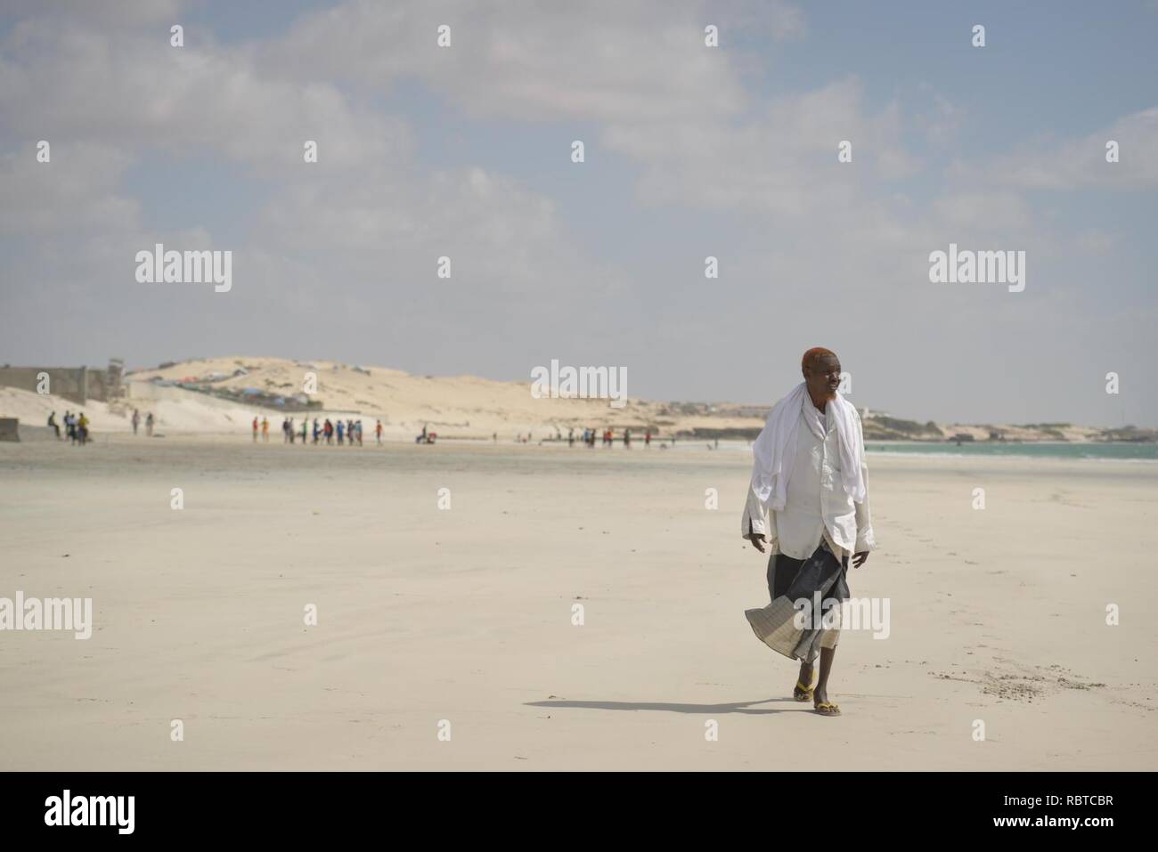 A Somali man talks a walk down Lido beach on December 21 in Mogadishu ...