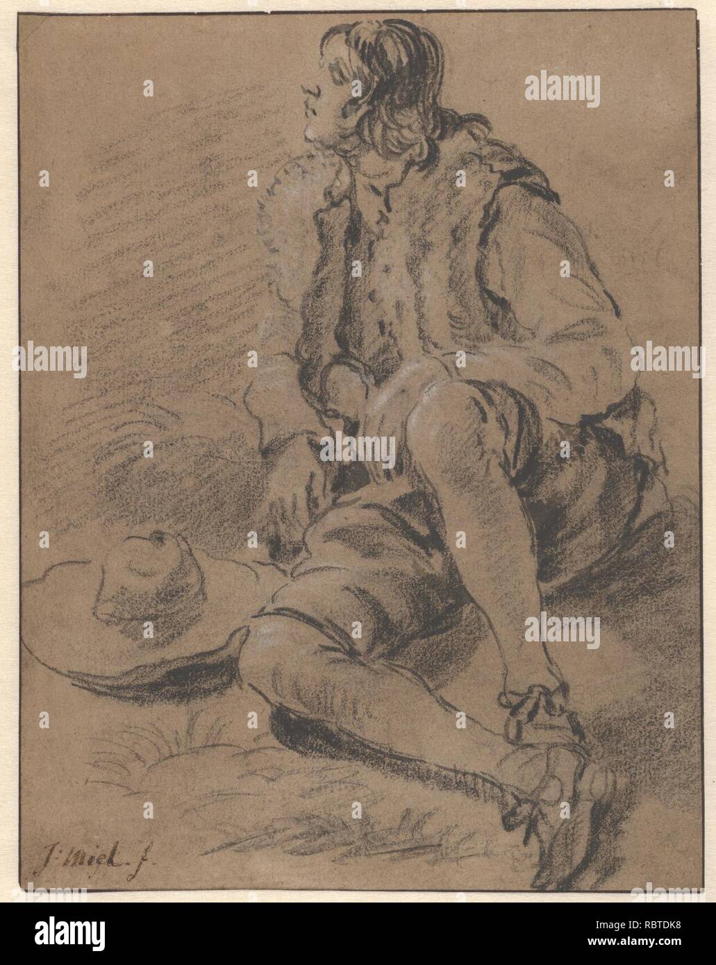 A Young Man Seated on the Ground Stock Photo - Alamy