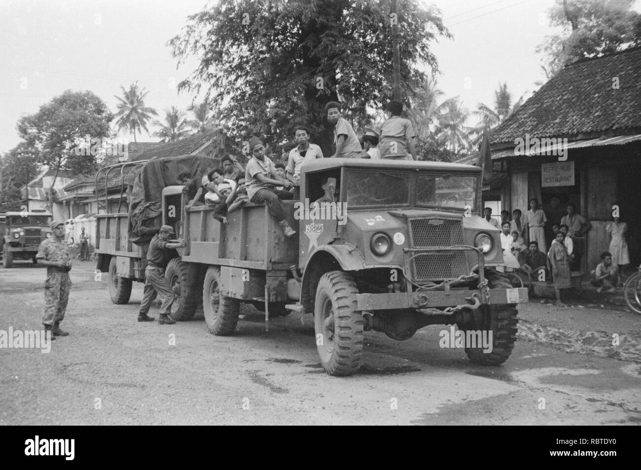 A.A.T. trucks van de W.-Brig. volgeladen met TNI-soldaten passeren ...