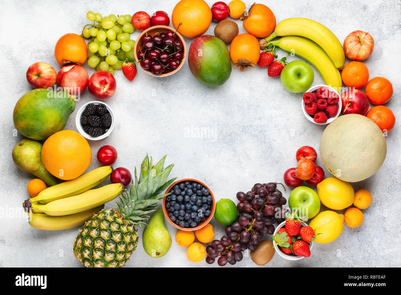 Healthy fruit background frame, strawberries raspberries oranges plums ...