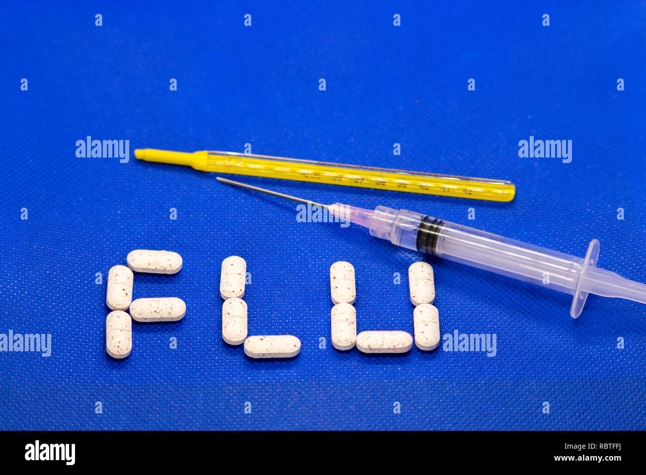 Set of cold medicine and flu virus on blue background. Antibiotics ...
