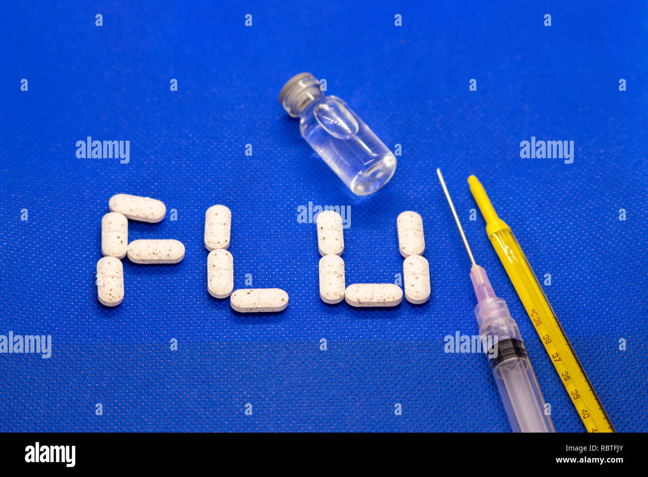 Set of cold medicine and flu virus on blue background. Antibiotics ...